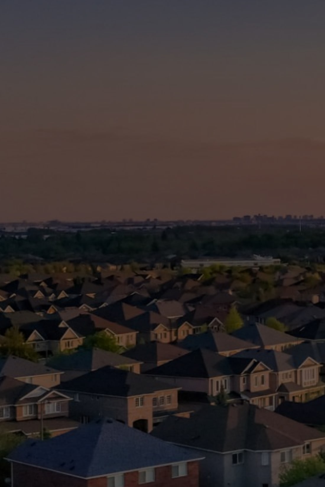 Aerial view of residential neighborhood with open sky and city skyline ...